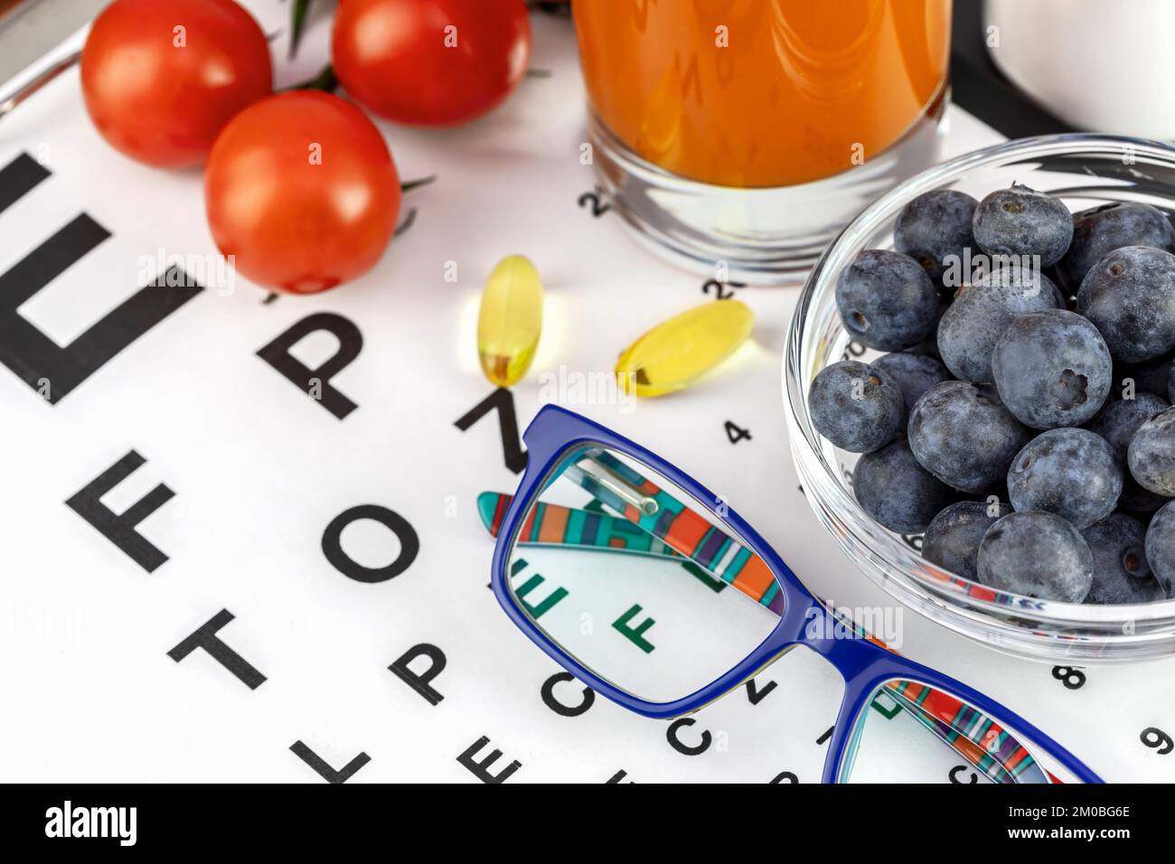 Food with vitamin A products to improve vision. Tomatoes, glass of ...