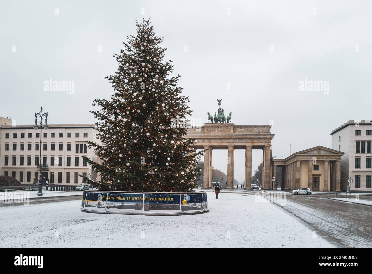 a colorfully decorated Christmas tree stands in front of the ...