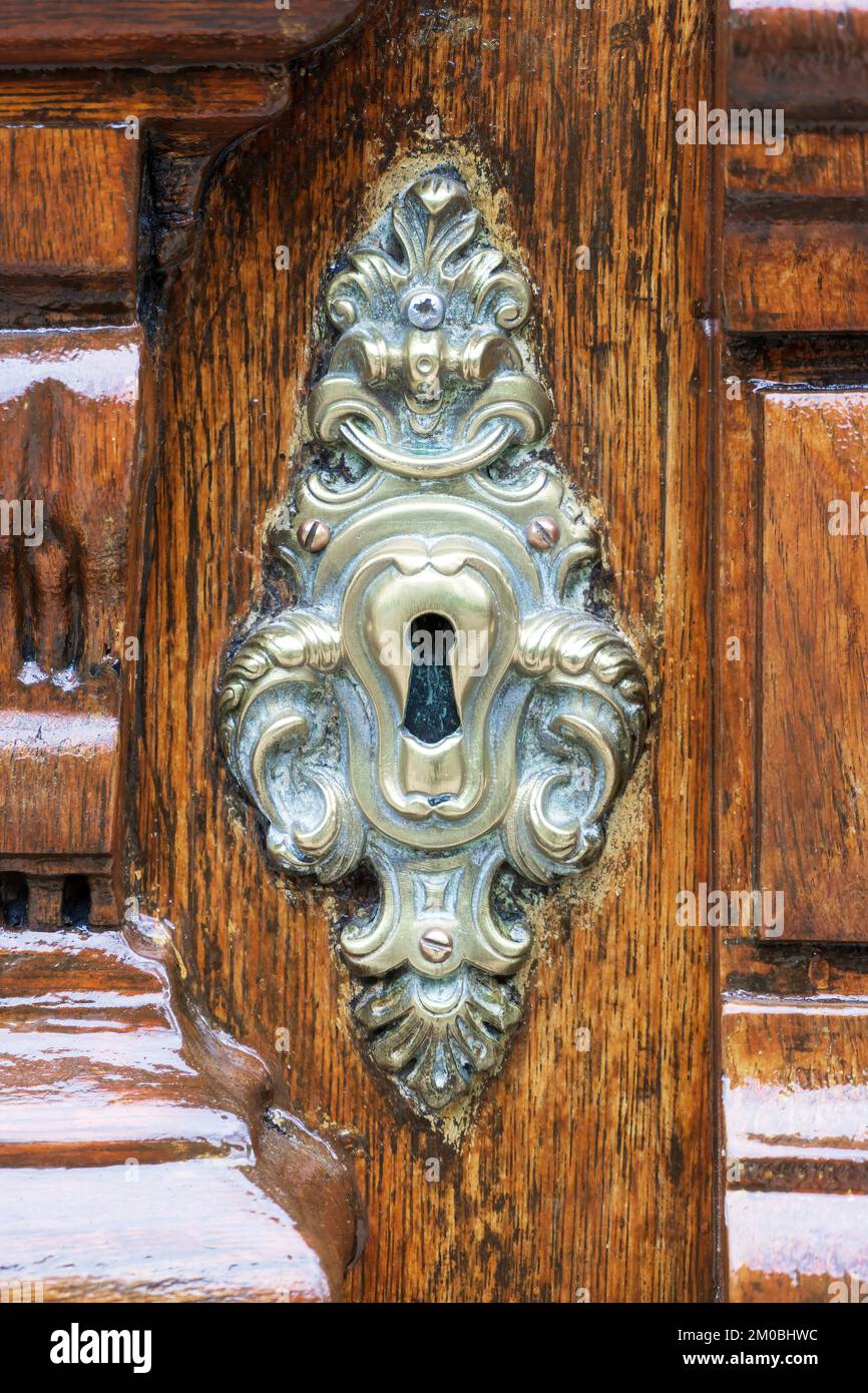 An antique metal lock on a varnished wooden door Stock Photo - Alamy