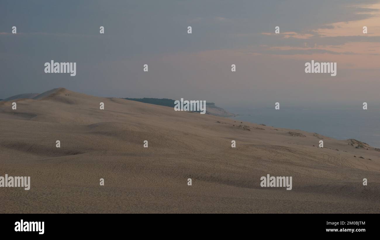 Sunset with view at the sea on a huge natural sand formation on the ...