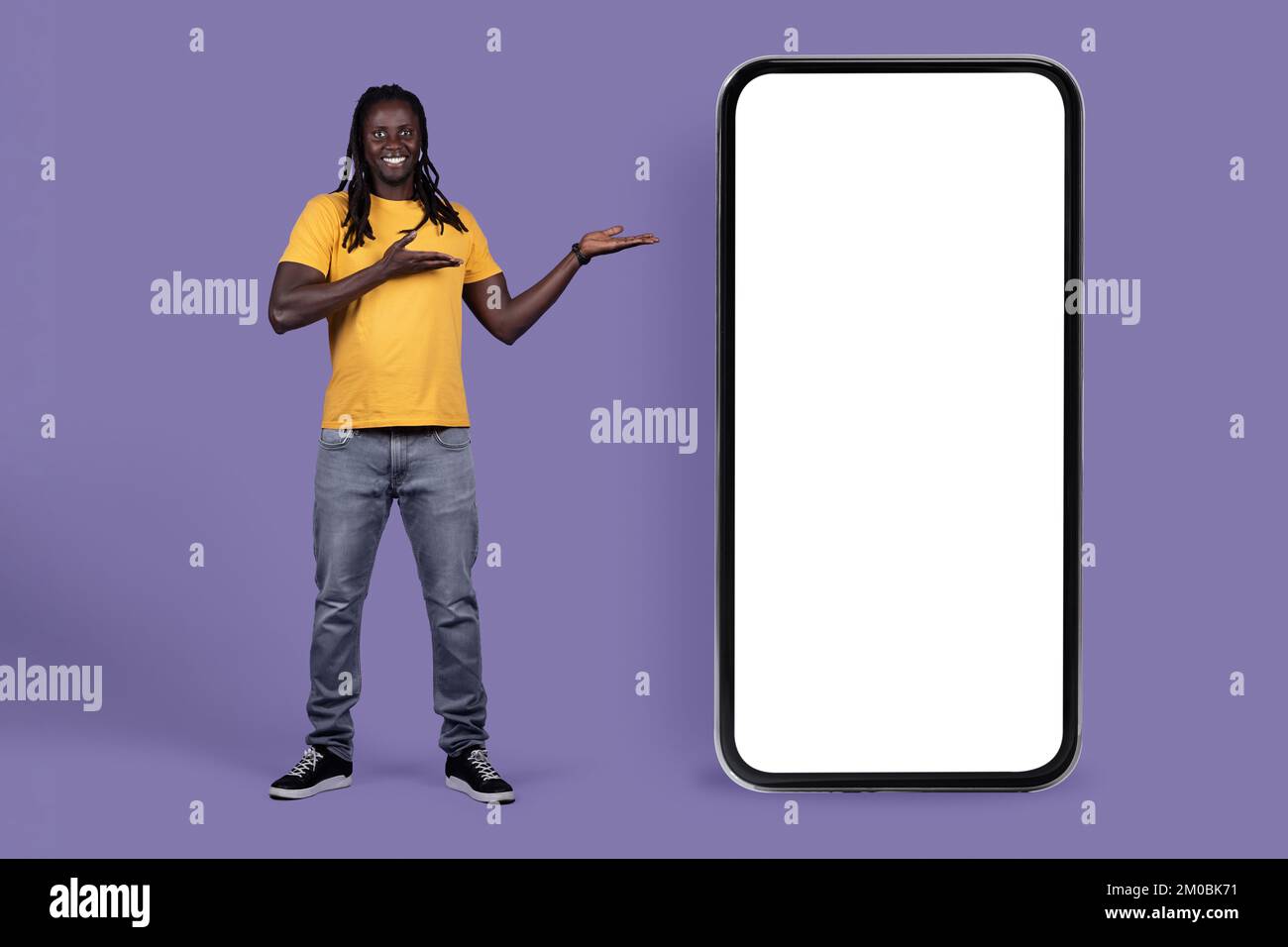 Handsome cool black guy pointing at big cell phone, mockup Stock Photo ...