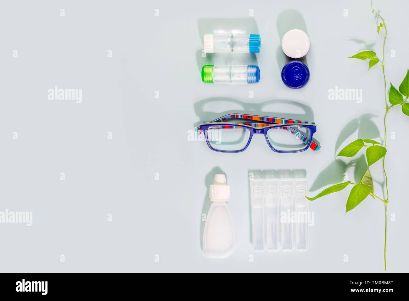 Oftalmology concept with kid eyeglasses, containers with contact lenses ...