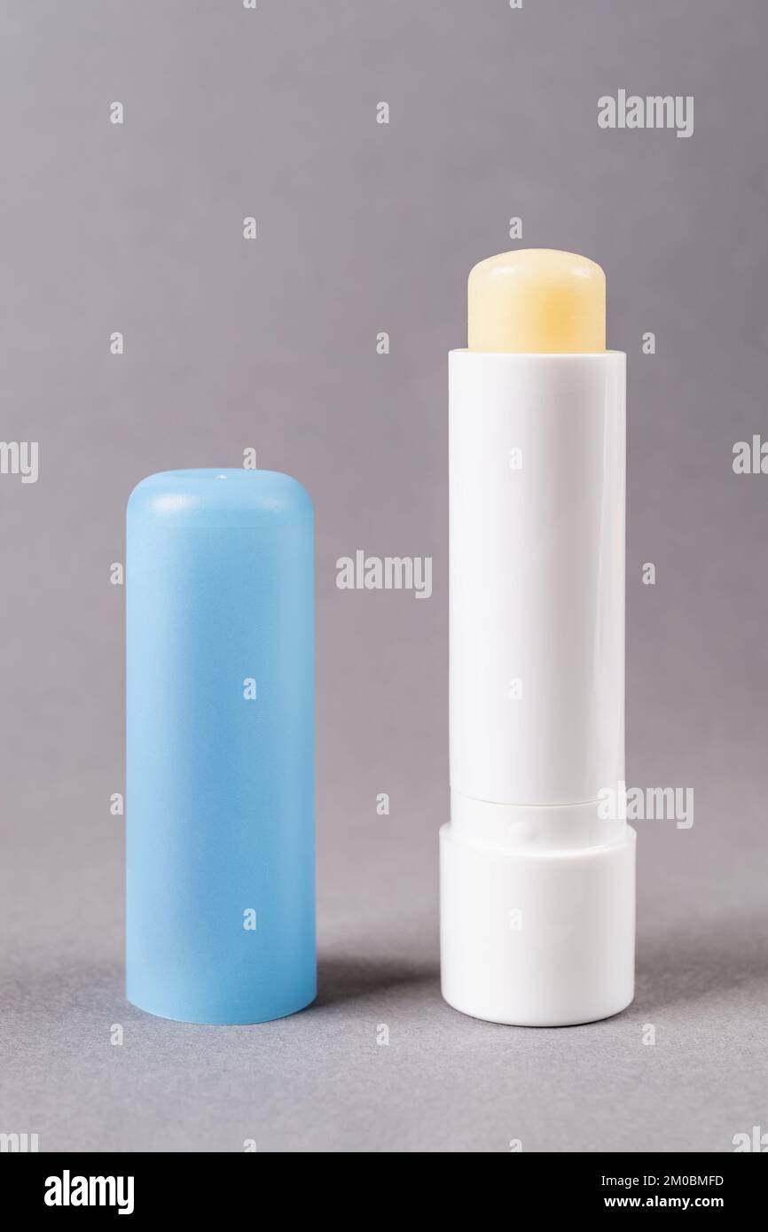 Chapstick open tube over gray background. Moisturizing lip balm for dry ...