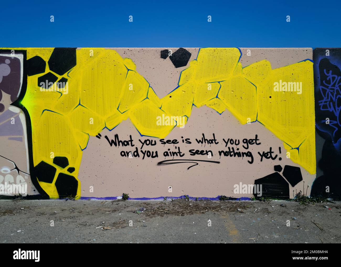A yellow Graffiti art with a text in Dortmund Stock Photo - Alamy