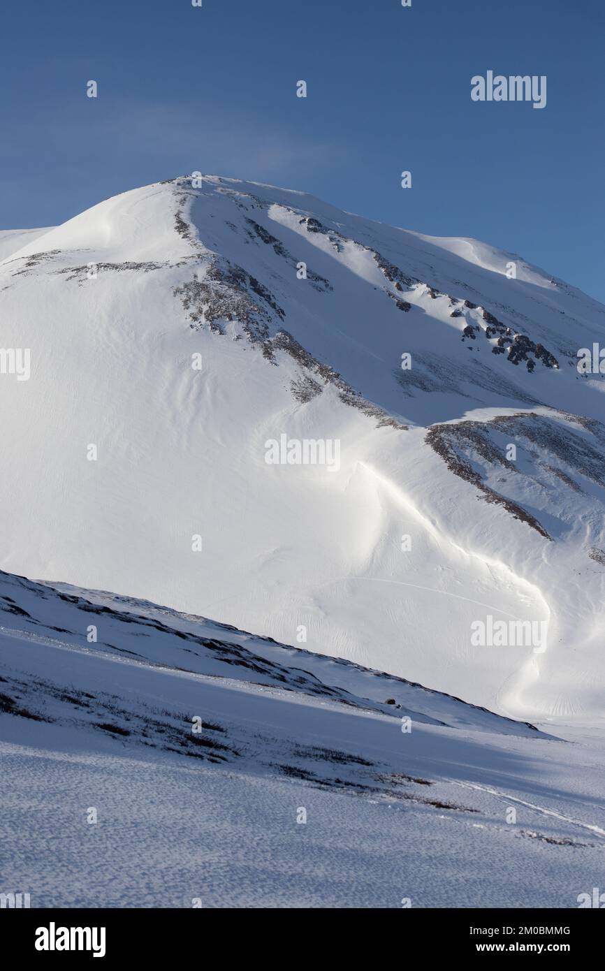 Scenic mountain slope covered with white snow. Exploring mountains in ...