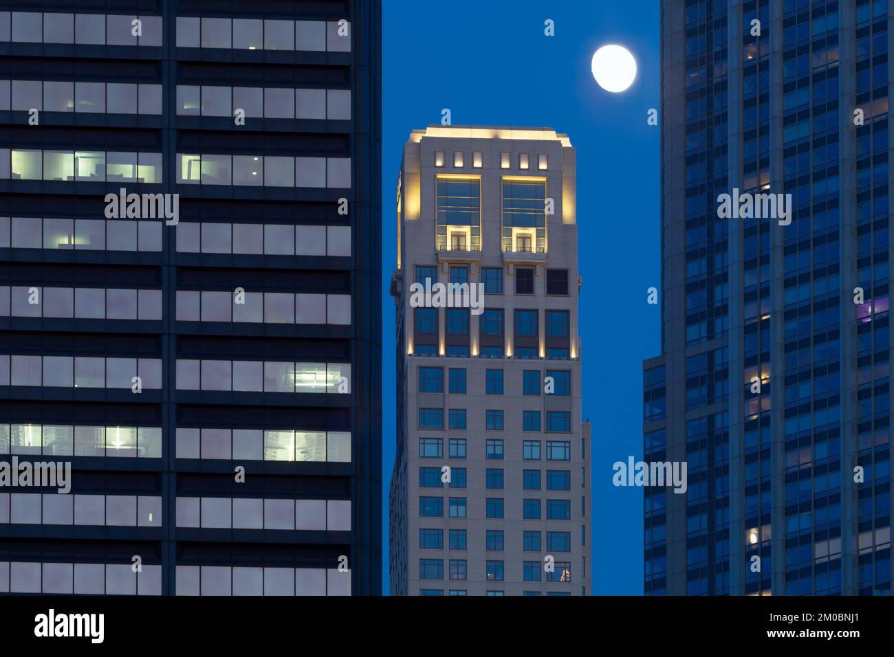 Moon over Chicago's downtown highrise architecture Stock Photo - Alamy