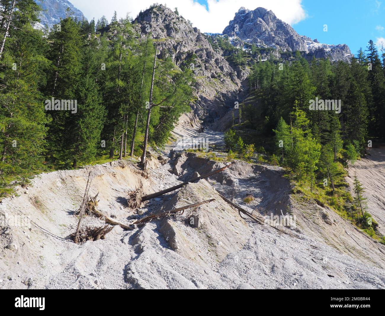 An Erosion alpine mountain slope with scree avalanche and masses of ...