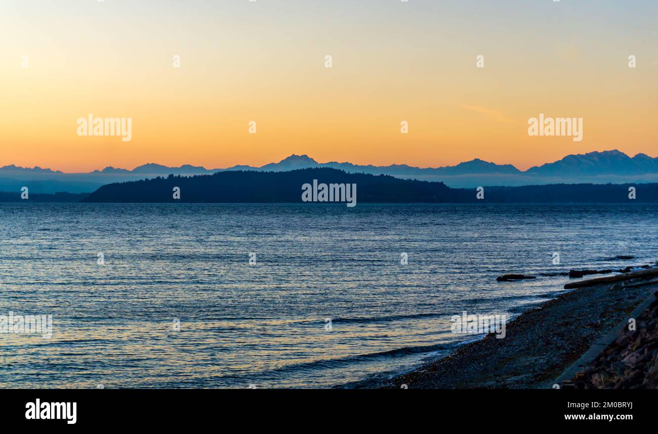 Sunset behind the Olympic Mountains across the Puget Sound Stock Photo ...