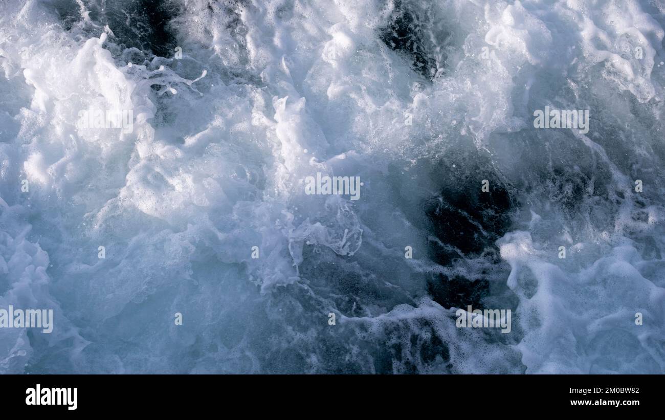 Abstract blue sea water with white foam for background, nature ...