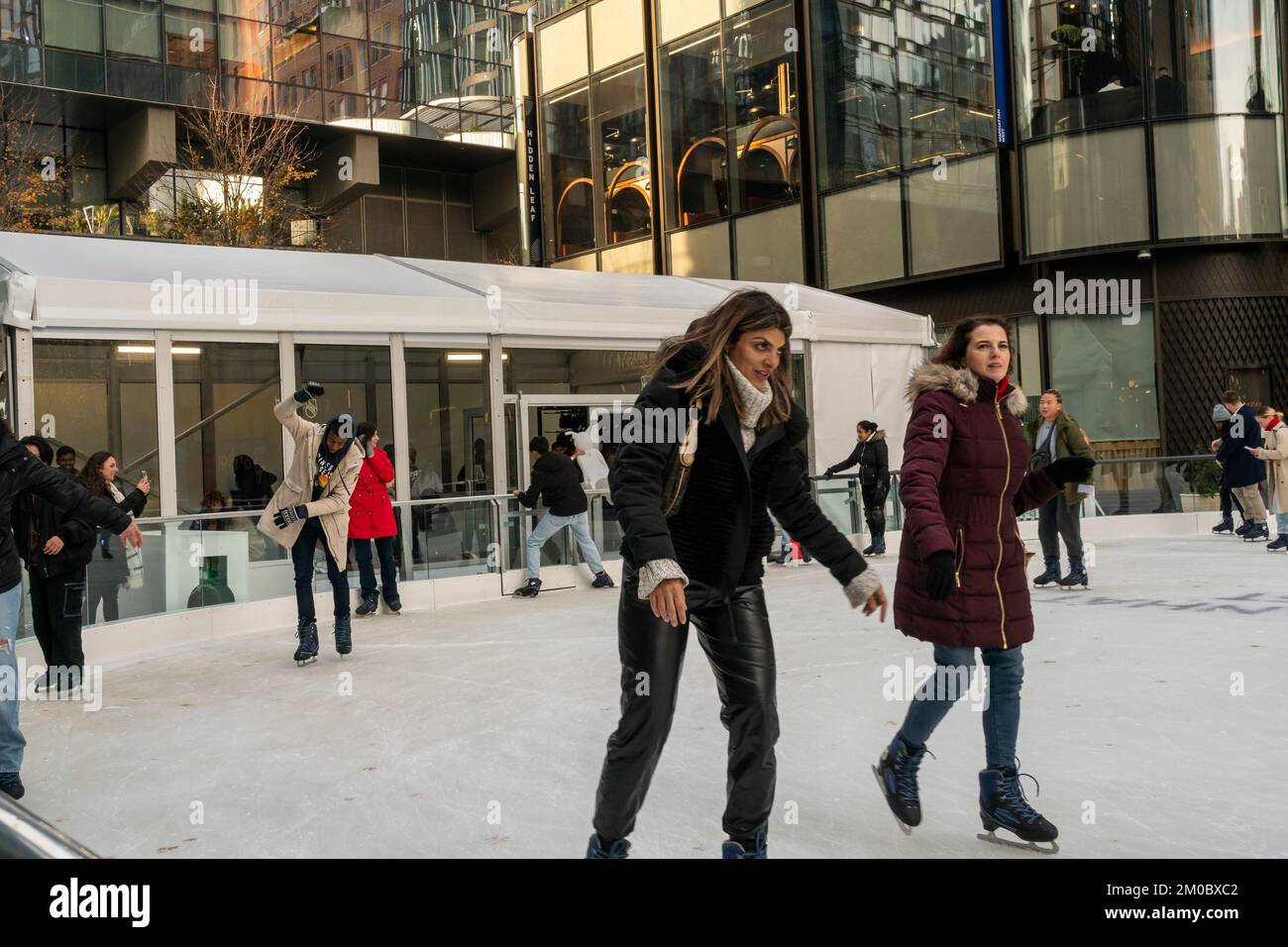 Skaters maneuver the ice skating rink at the Manhattan West development ...