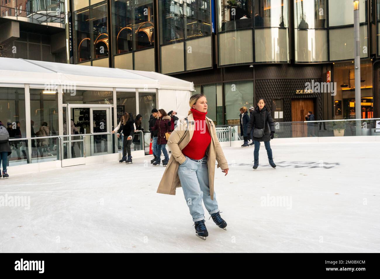 Skaters maneuver the ice skating rink at the Manhattan West development ...