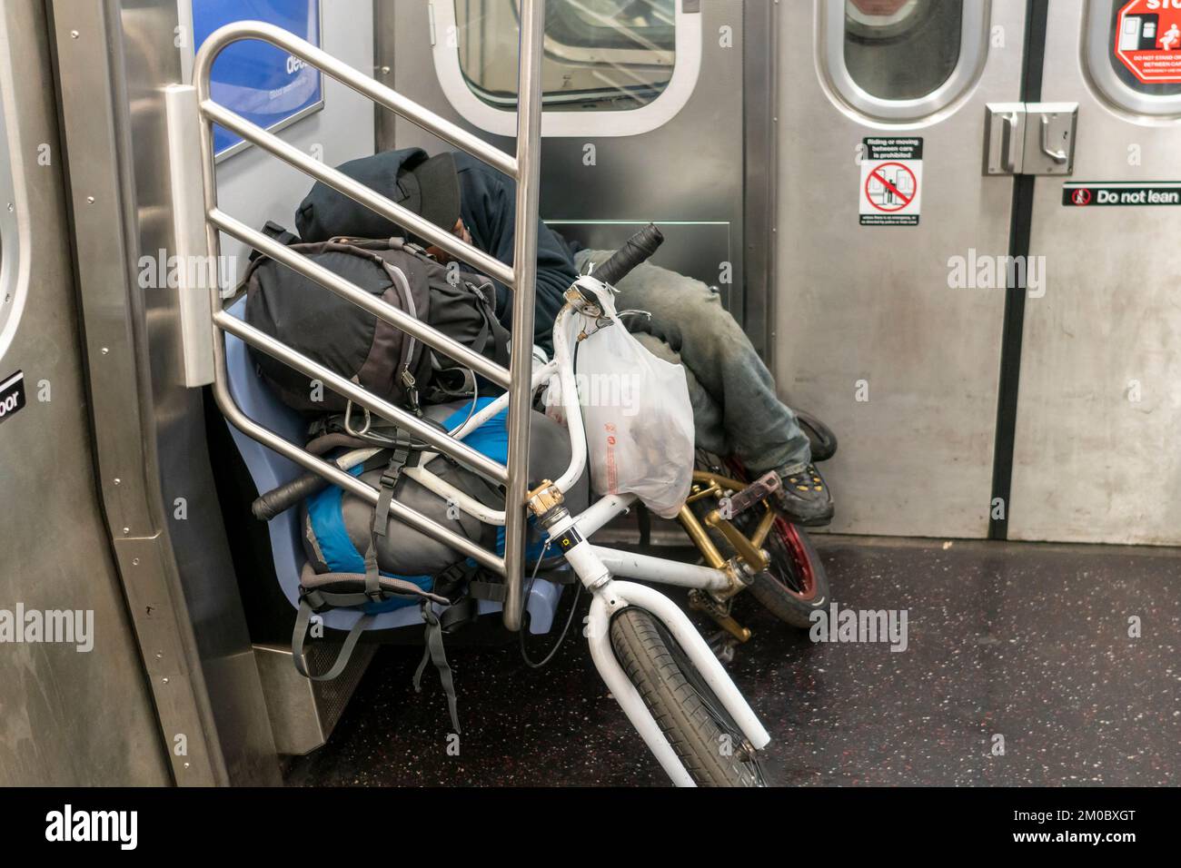 Homeless man asleep on an A line subway train in New York on Sunday ...