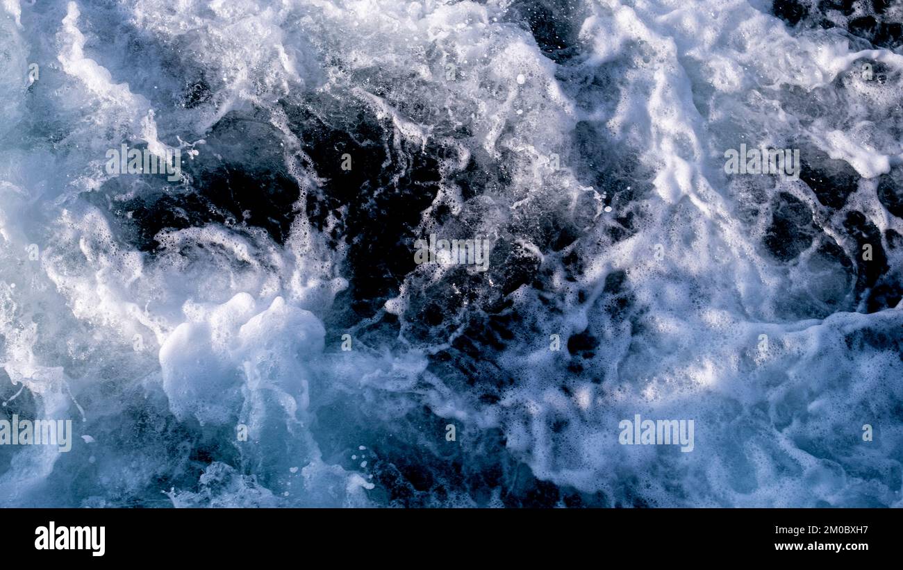 Abstract blue sea water with white foam for background, nature ...
