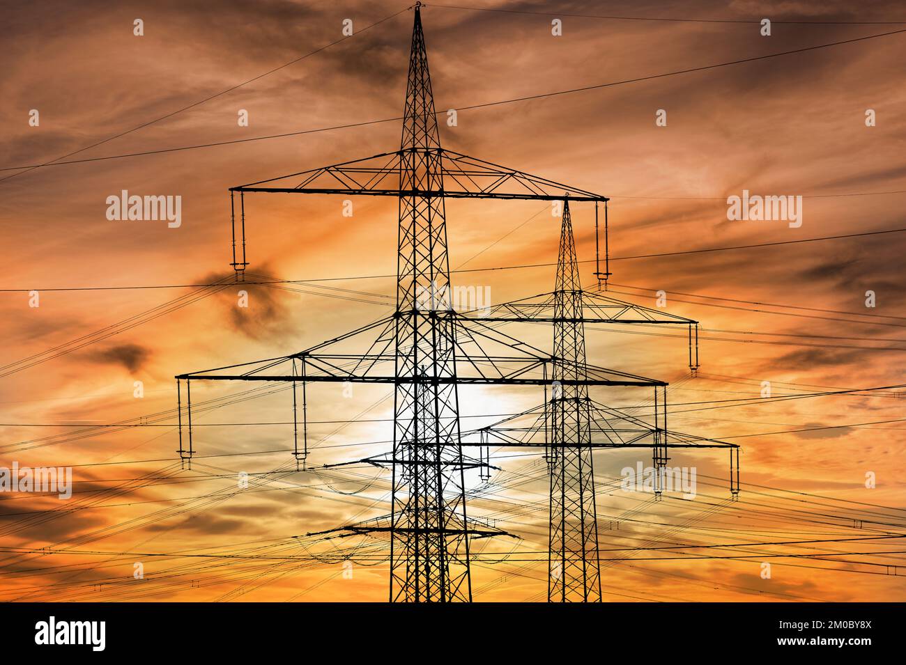 high voltage and electric pylons against sky with clouds Stock Photo ...