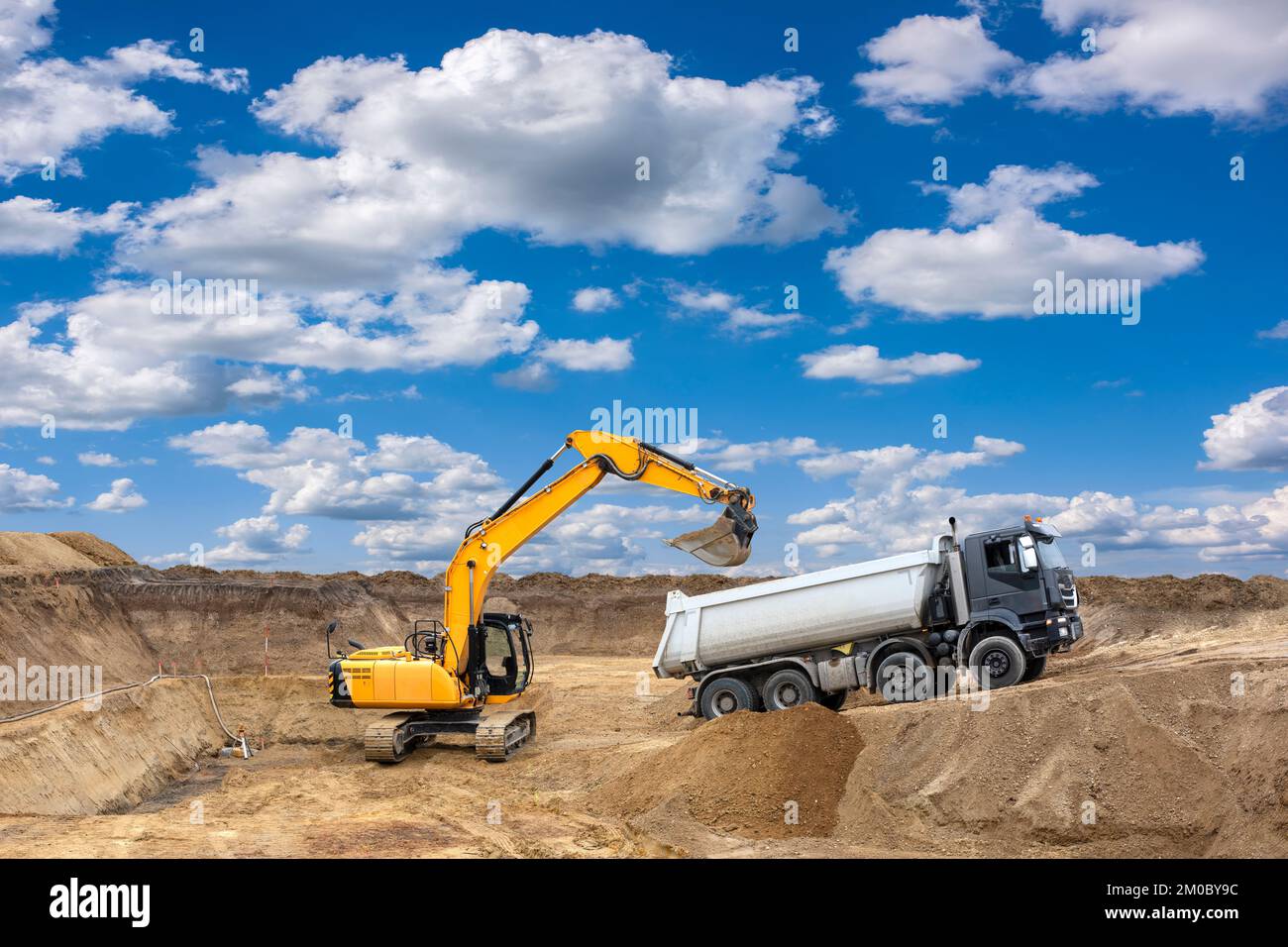 excavator is working and digging in construction site Stock Photo - Alamy