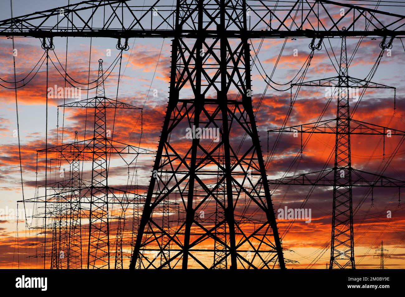 high voltage and electric pylons against sky with clouds Stock Photo ...