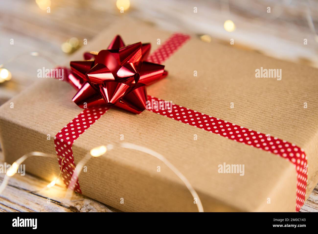 Above view of festive gift box wrapping in craft paper with festive ...