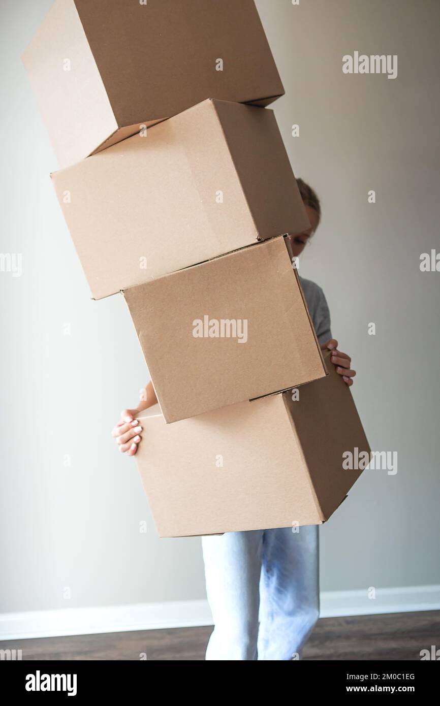 Happy girl moving in new house with cardboard boxes Stock Photo - Alamy