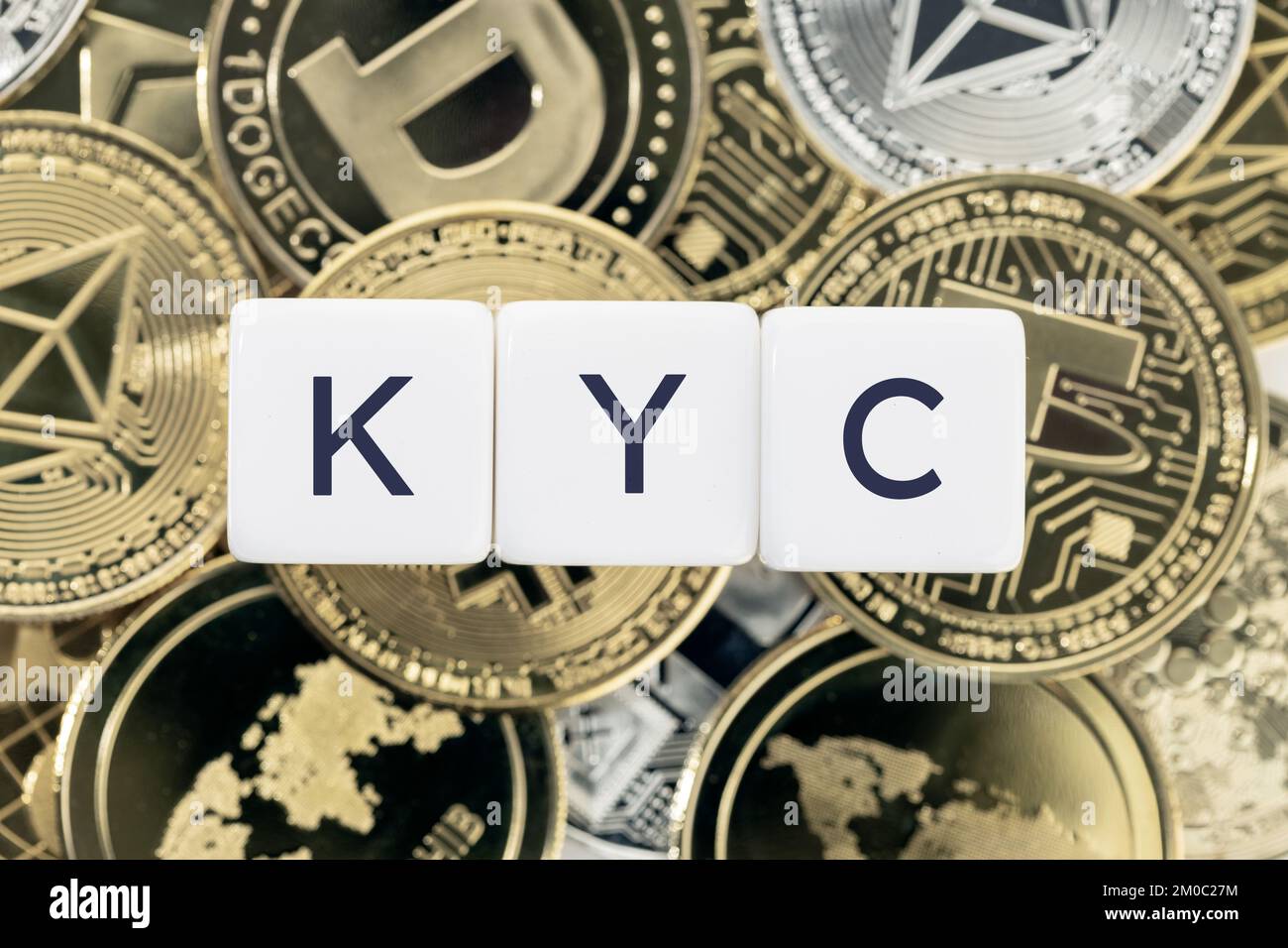 KYC or Know Your Customer concept. Text on cube blocks on crypto coins ...