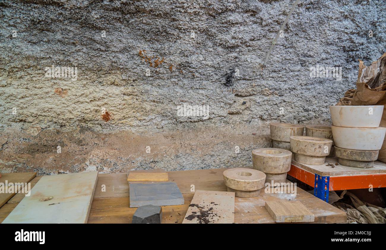 Table of ceramic workshop full of bags of clay material, mud, tools ...