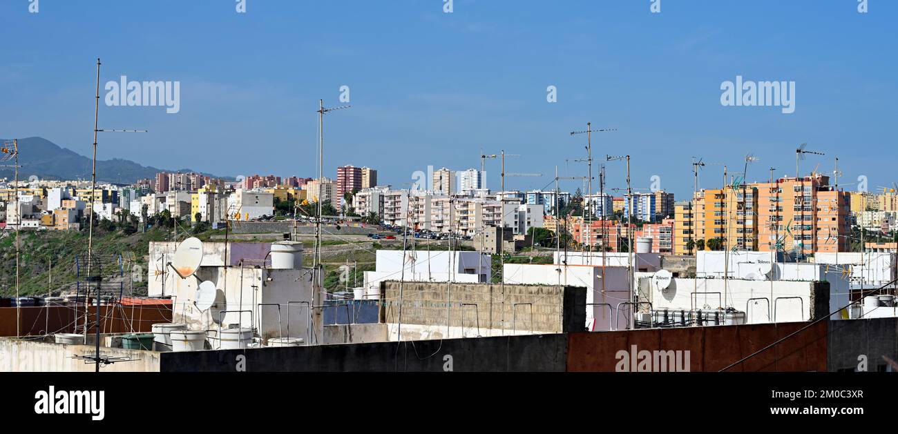 Rooftops with TV aerials on houses with skyline of Las Palmas behind ...