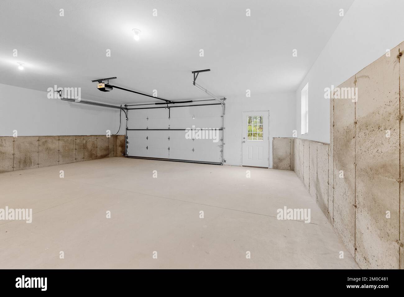 An inside view of an empty room in a newly constructed house with white ...