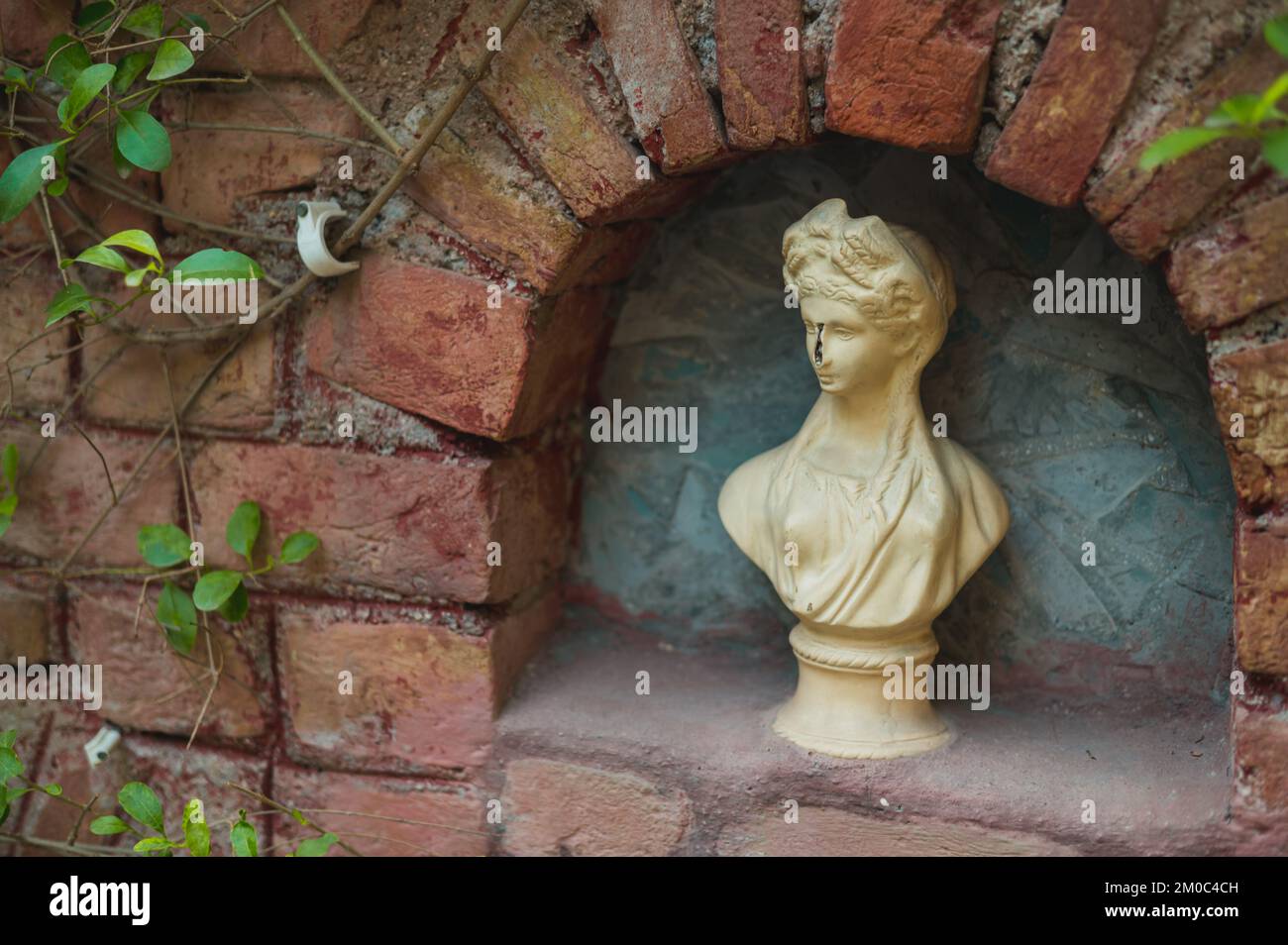 Head of marble statue of roman Ceres or greek Demeter in the park of ...