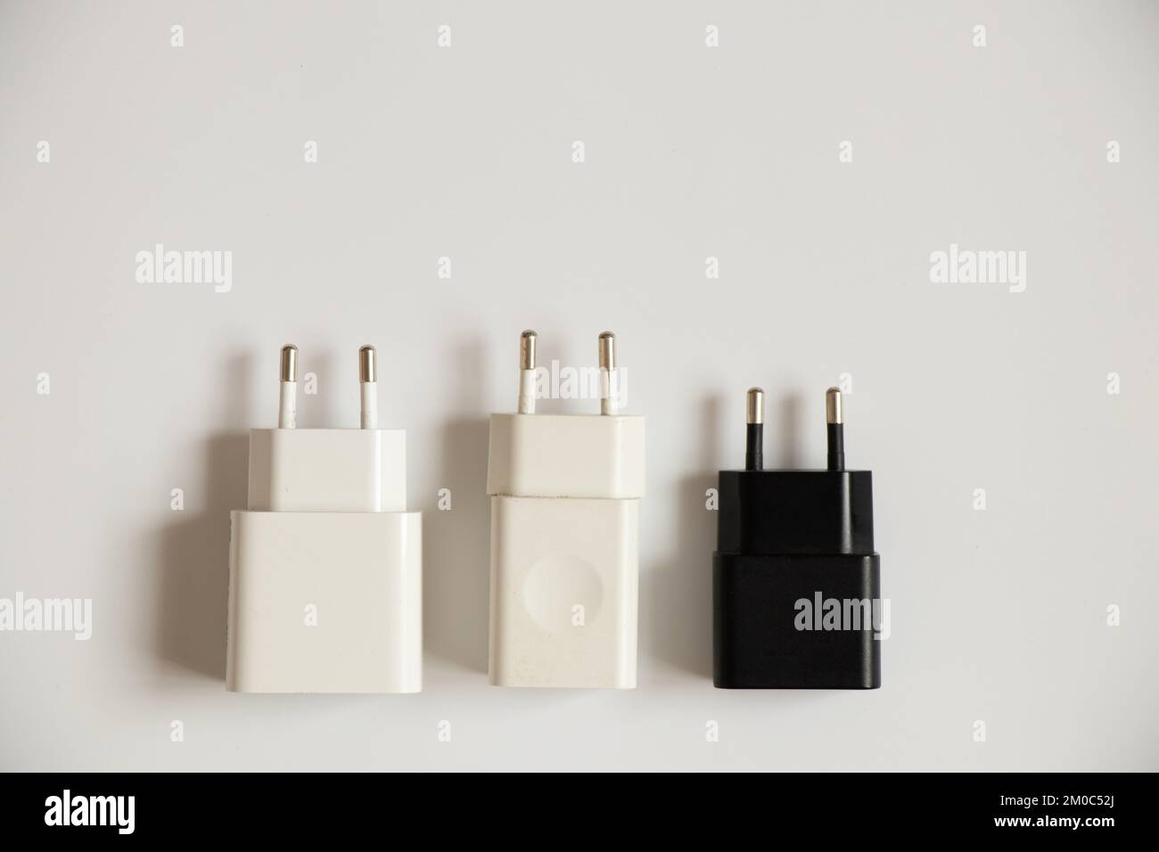 Charging blocks for the phone lie on a white background close-up, three ...