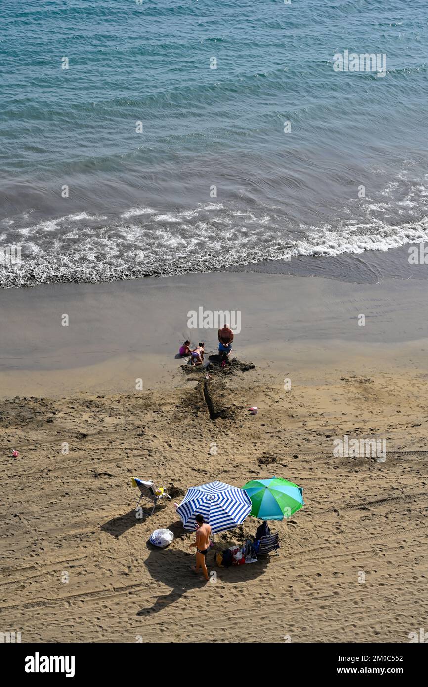 Playa El Veril beach with sunbathers on sand others in the sea, San ...