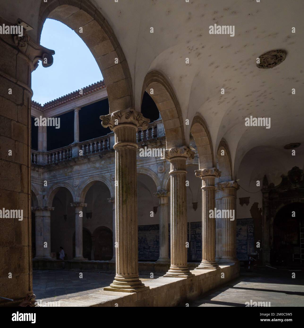 Ornate medieval arches and behind the cloister and the blue azulejo ...