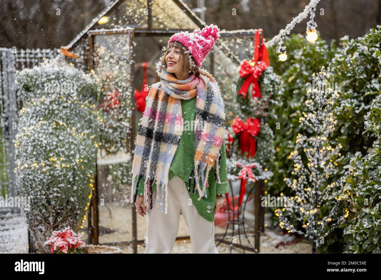Woman enjoys winter holidays at beautifully decorated backyard Stock ...