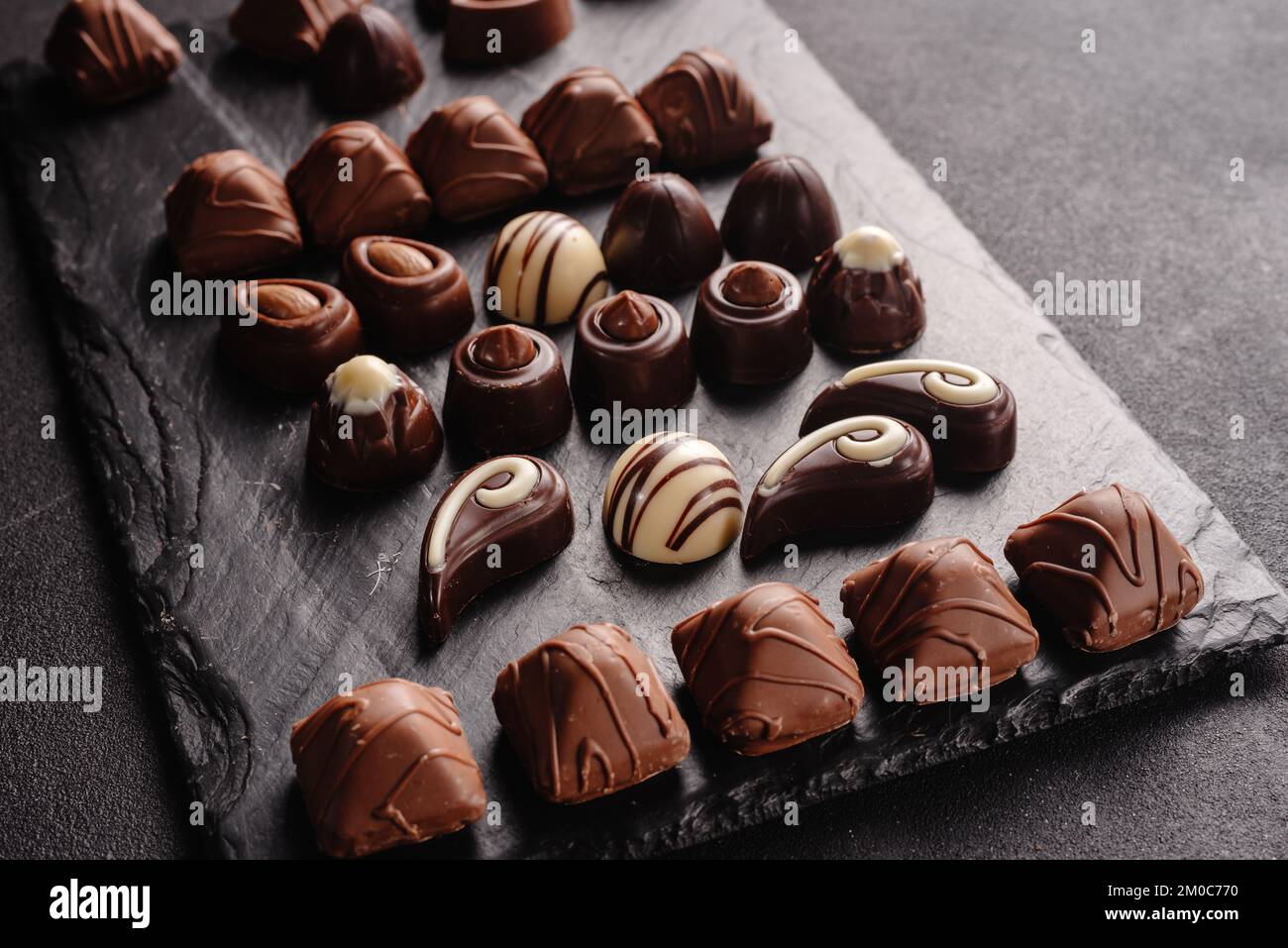 A lot of different chocolates. An assortment of delicious chocolates in ...