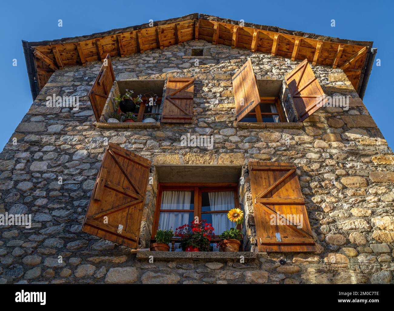 Old rural stone house in the Pyrenees with open wooden windows and ...
