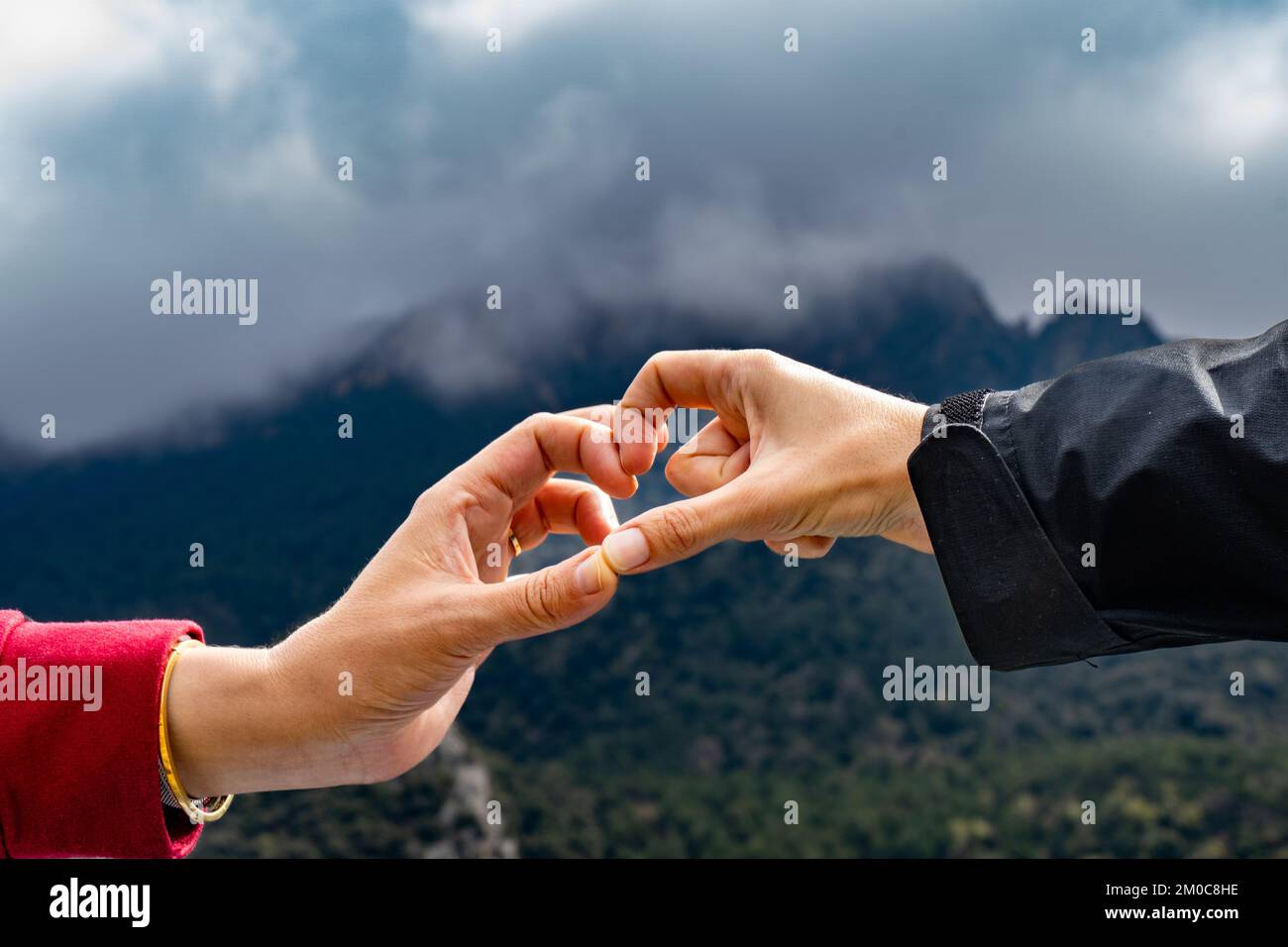 Two hands touching each other making the shape of the heart with a ...