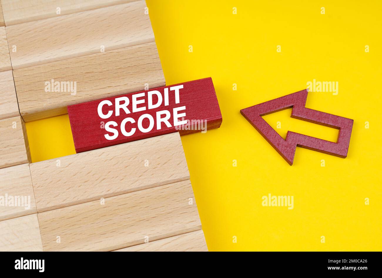 Business concept. On a yellow surface are wooden blocks and an arrow ...