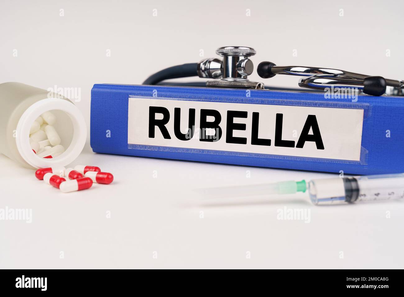 Medical concept. On a white surface there are pills, a syringe, a ...
