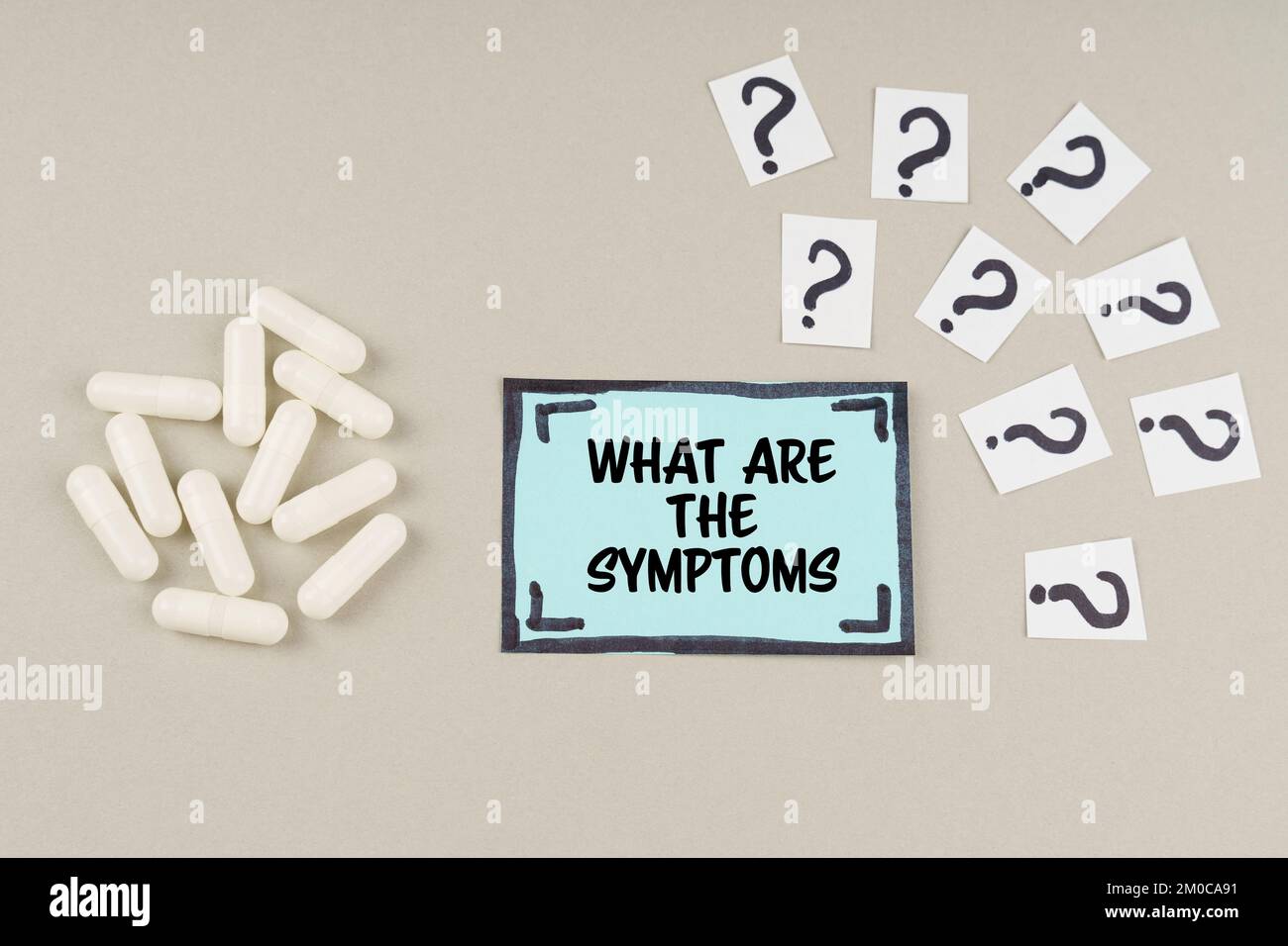 Medical concept. On a gray surface there are question marks and a blue ...