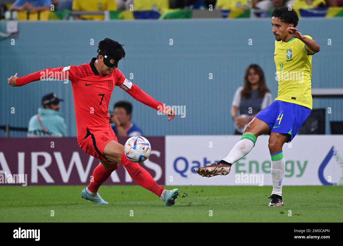 Doha, Qatar. 5th Dec, 2022. Son Heung-min (L) of South Korea vies with ...