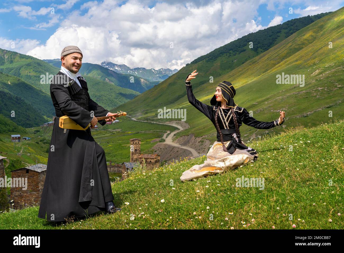 Georgian woman dancing and Georgian man playing local musical ...