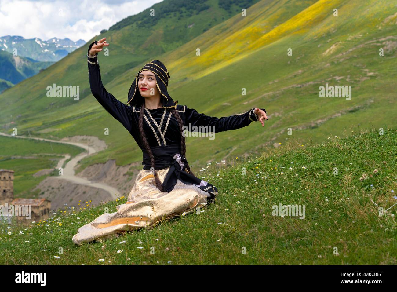 Georgian woman in local dress dancing in Ushguli, Georgia Stock Photo ...