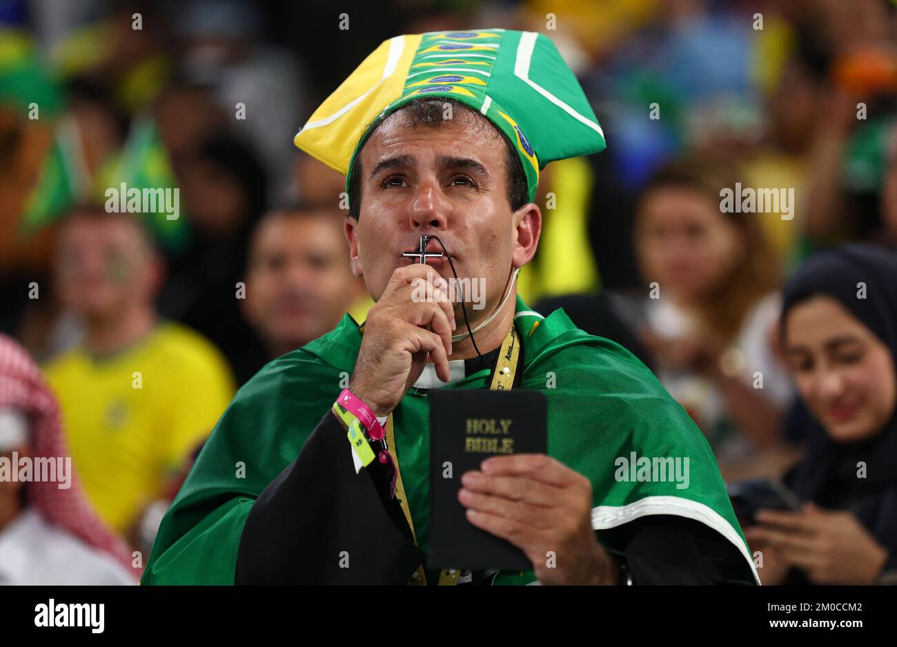 Doha, Qatar, 5th December 2022. Brazil fan seeking guidance from a ...
