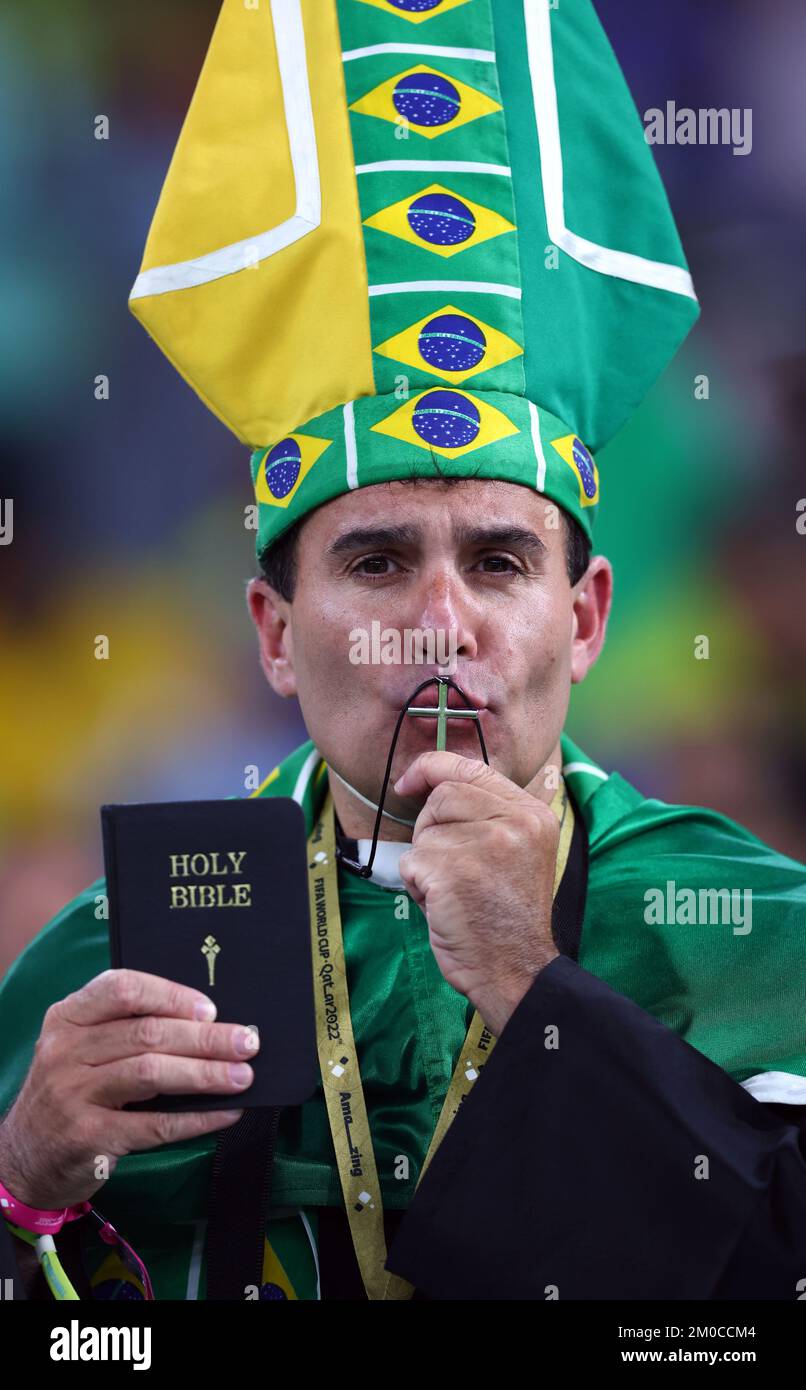 Doha, Qatar, 5th December 2022. Brazil fan seeking guidance from a ...