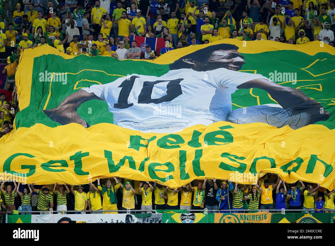 Brazil fans in the stands hold up a banner wishing for former player ...