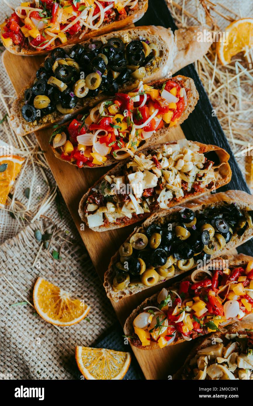 A vertical shot of bruschetta set with vegetables, mushrooms, and ...