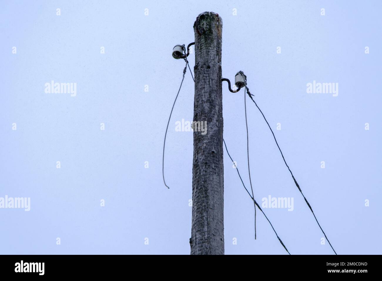 Old unnecessary wooden electric's pylon with broken wires Stock Photo ...