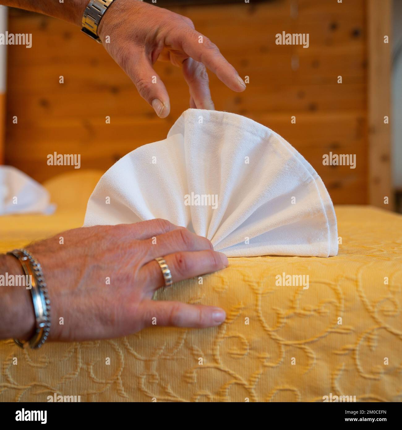 The male hands holding napkin for table setting on the table Stock ...