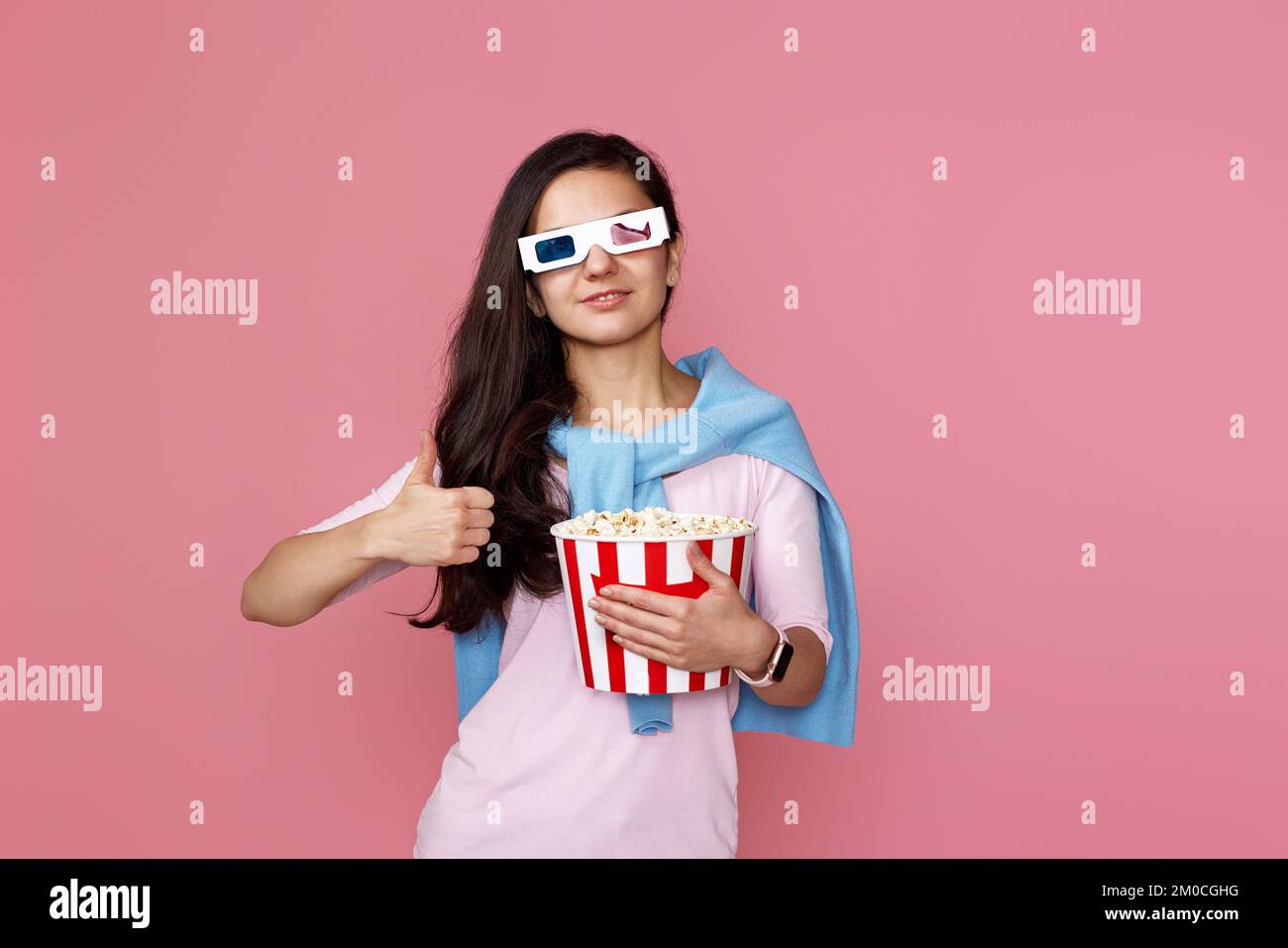 woman in hat with bucket of popcorn showing Ok gesture Stock Photo - Alamy