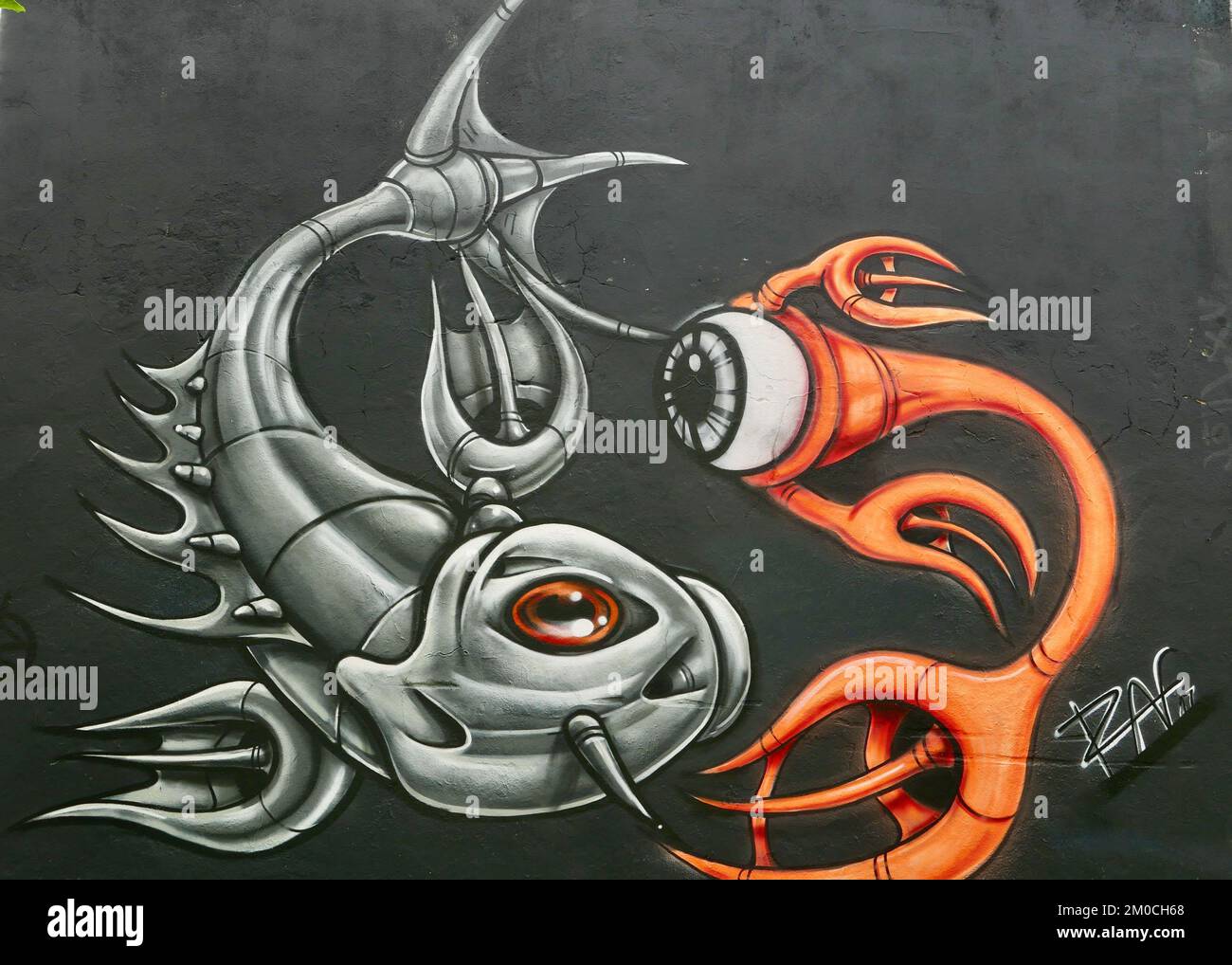 A closeup of creative graffiti depicting single-eyed fantasy alien fish ...