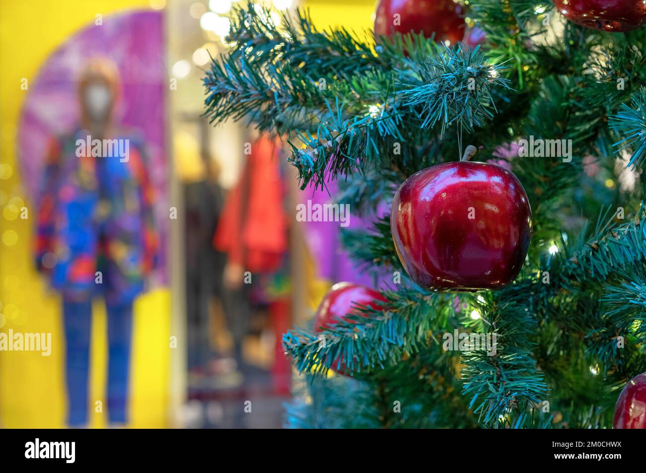 Red apple on the Christmas tree against the backdrop of a showcase with ...