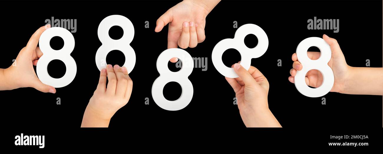 Number eight in hand isolated on black background. Number 8 in a child ...
